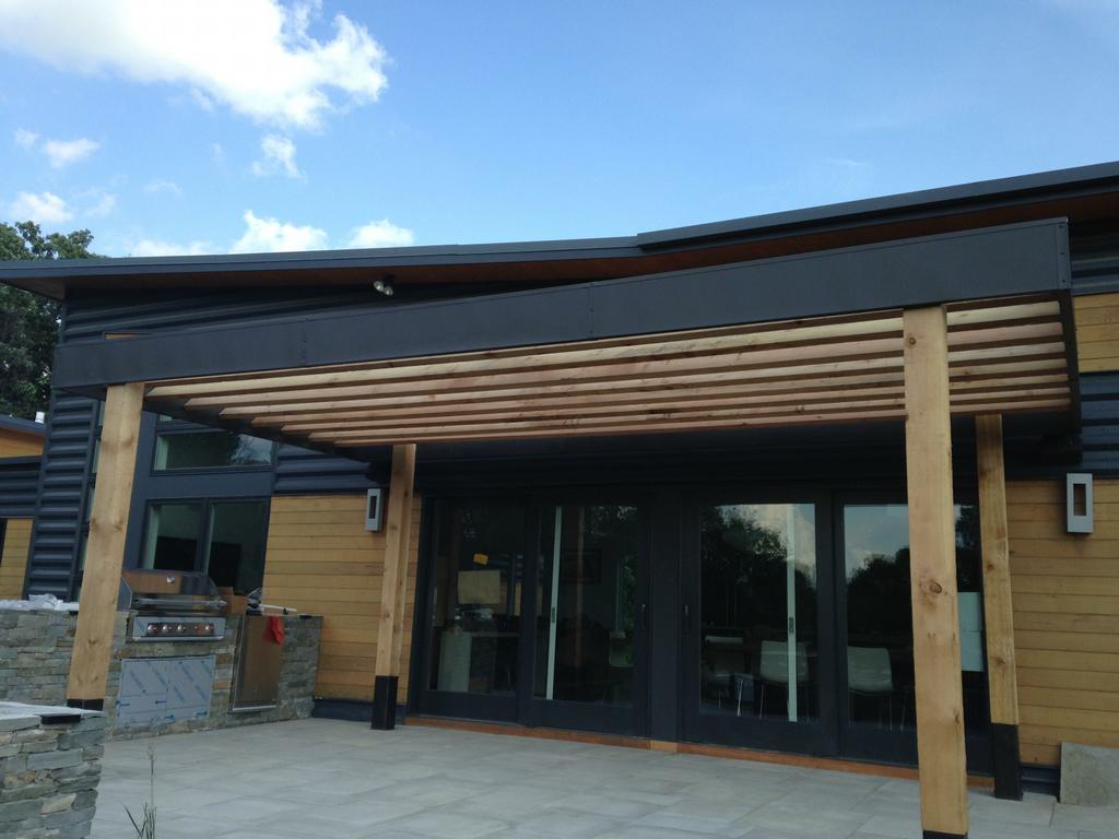 Heavy rough sawn beams support a louvered ceiling of cedar timber all ...